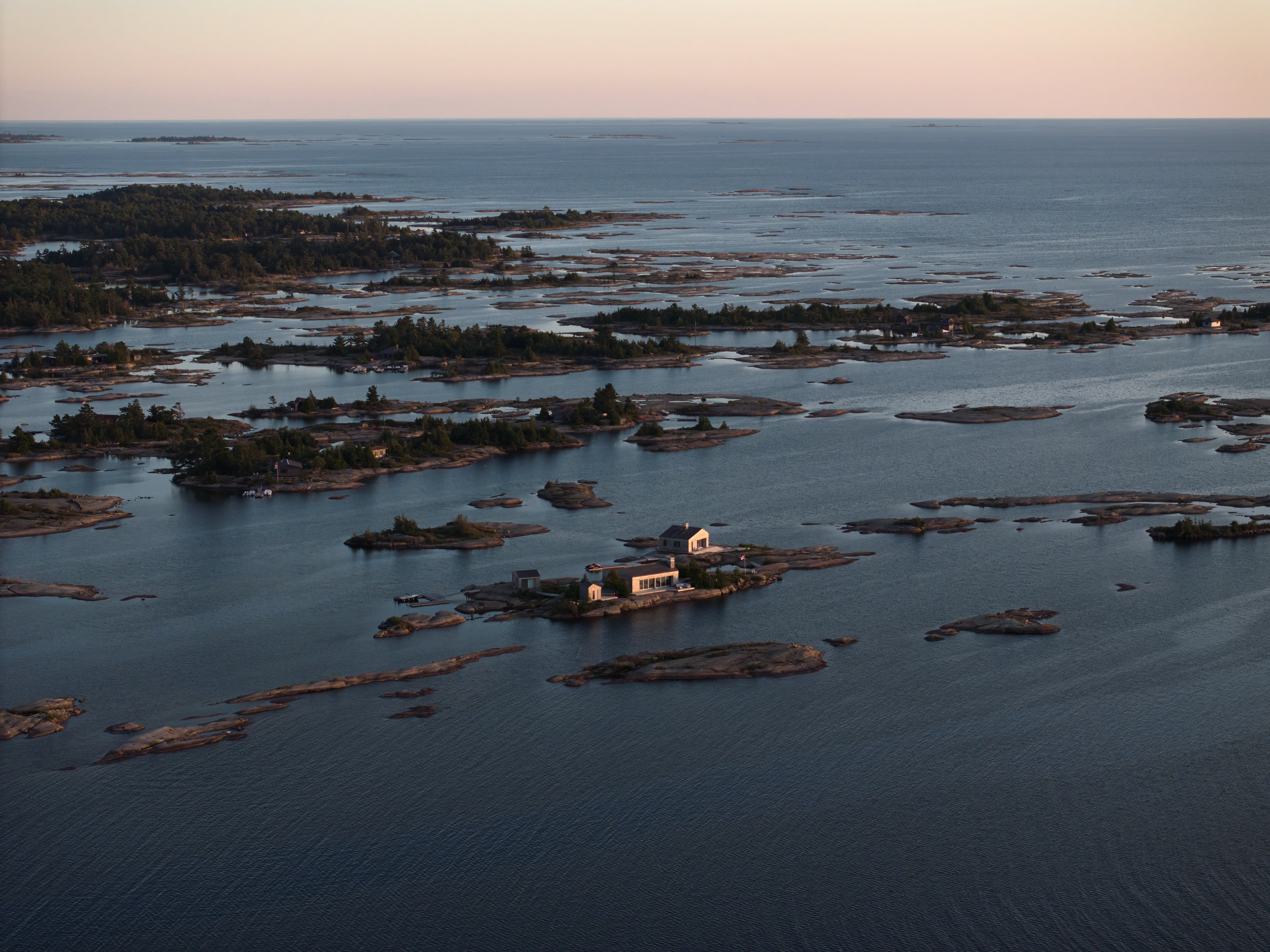 Modern summer home by Akb emerges from cluster of scattered islands in ...