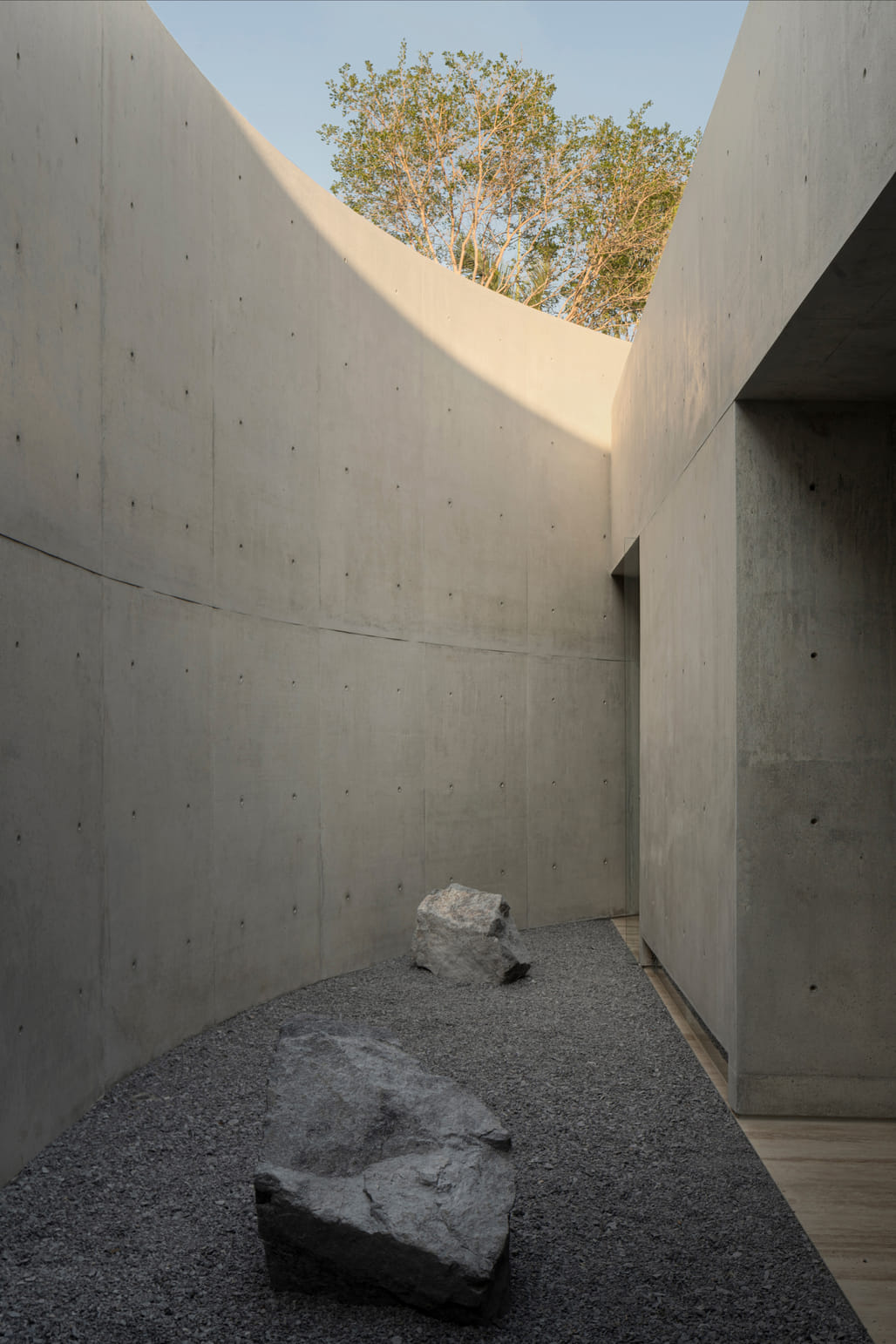 A minimalist concrete home defined by shaded courtyards and stillness ...