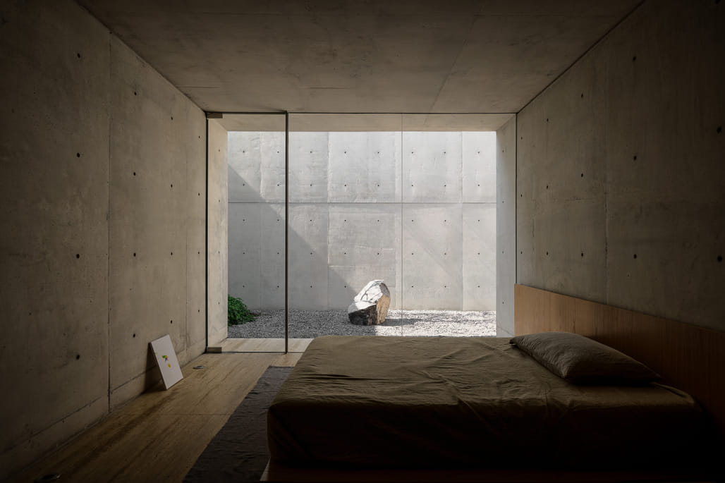A minimalist concrete home defined by shaded courtyards and stillness ...