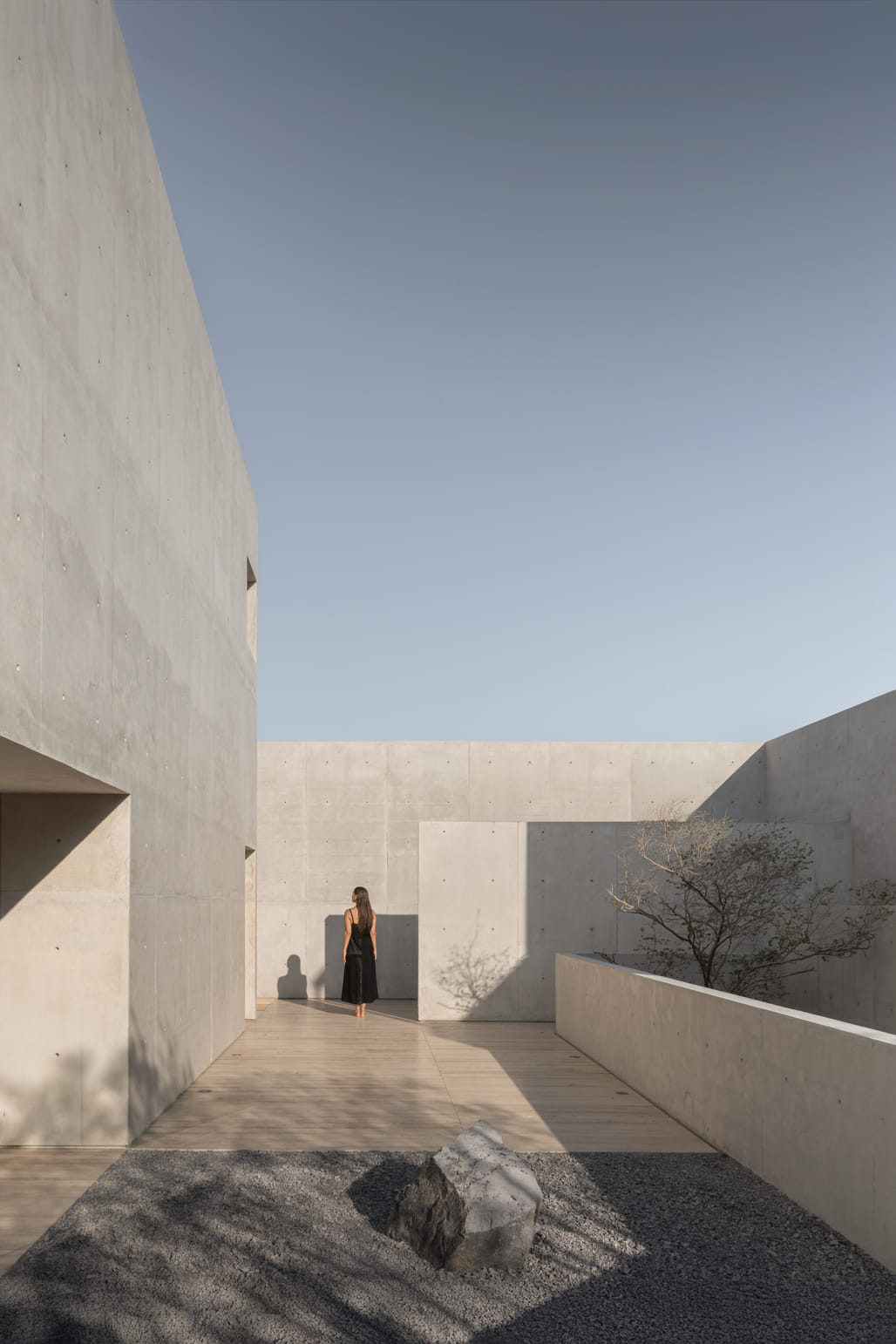A minimalist concrete home defined by shaded courtyards and stillness ...
