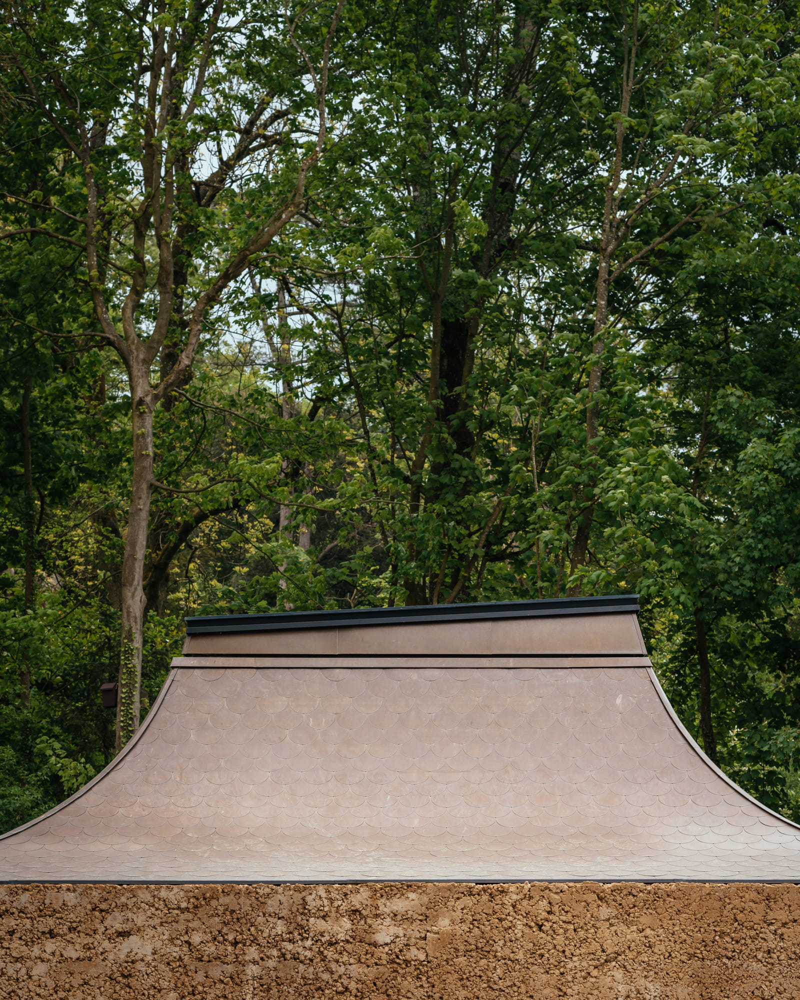 Invisible Studio creates rammed stone yoga studio in UK countryside ...